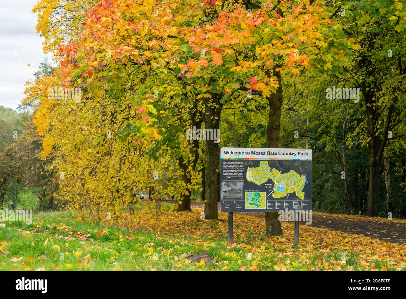 Entrance to Moses Gate Country Park in autumn with brightly coloured ...