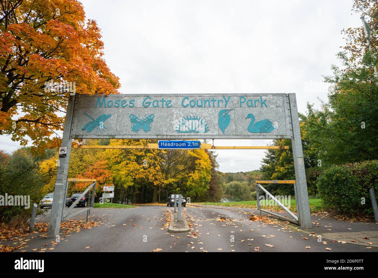 Entrance to Moses Gate Country Park in autumn with brightly coloured ...