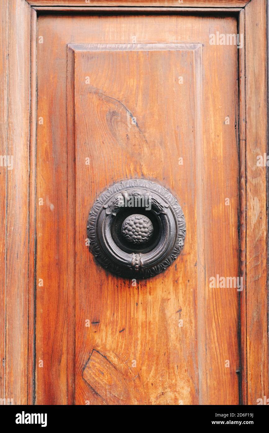 Vertical shot of an old wooden door with an ornate door knocker Stock ...
