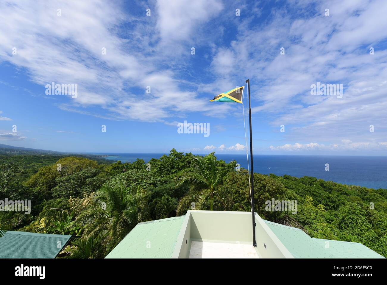 Flag of Jamaica waving against blue sky. Flag of Jamaica have a gold ...