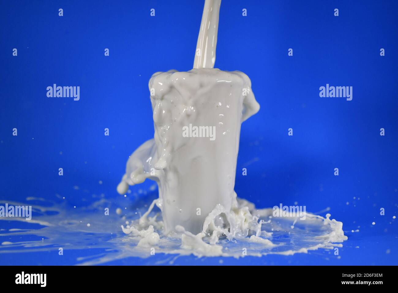 Shot of splashing milk from a cup Stock Photo - Alamy