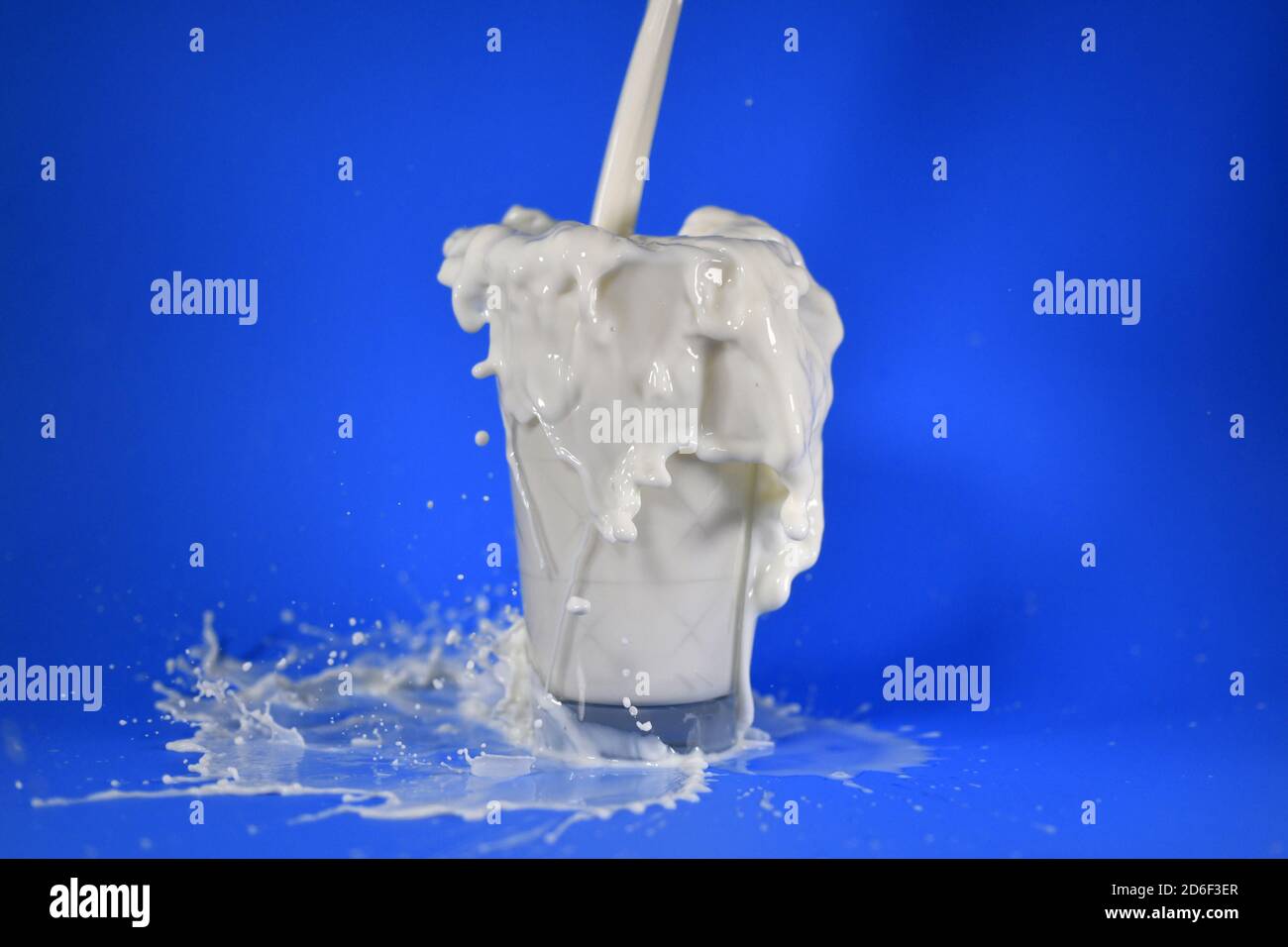 Shot of splashing milk from a cup Stock Photo - Alamy