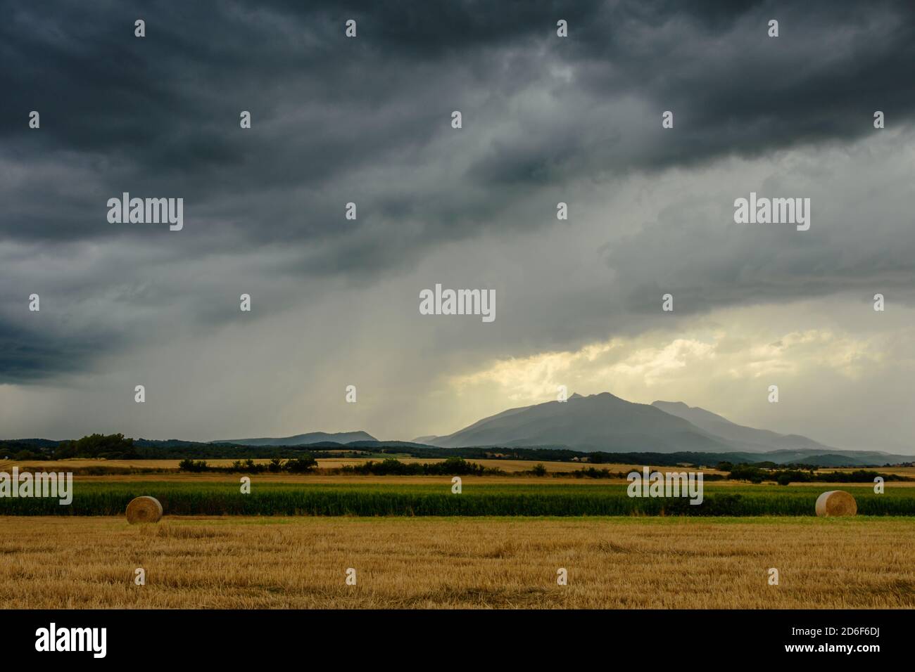 Dark rain clouds over field of harvested wheat Stock Photo - Alamy