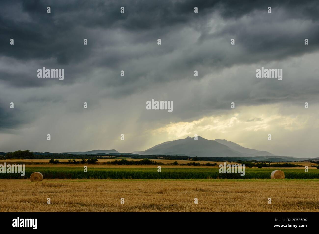 Dark rain clouds over field of harvested wheat Stock Photo - Alamy
