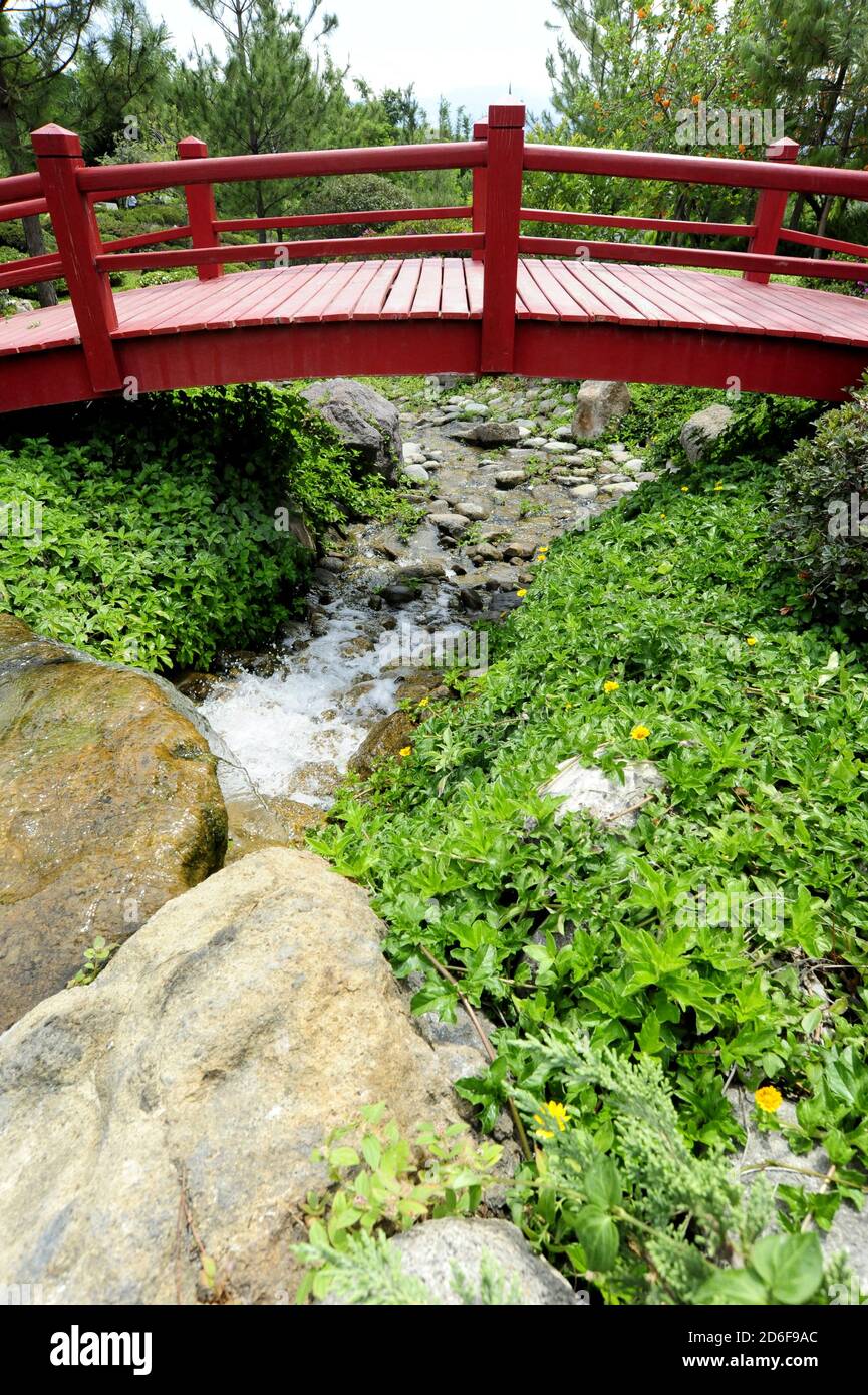 Shot of a red bridge on a tiny river Stock Photo - Alamy