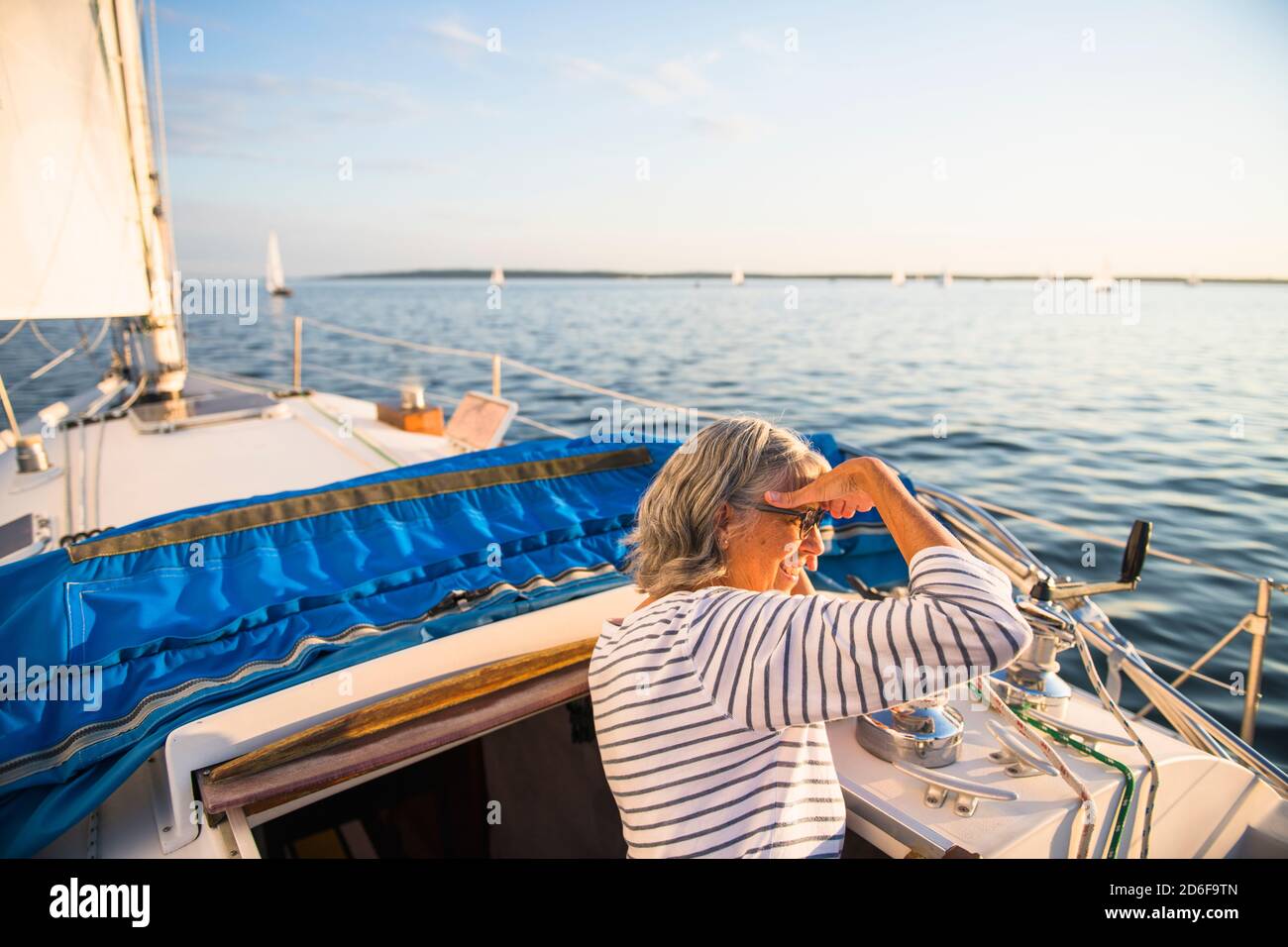 Middle age woman enjoying summer sail during golden hour Stock Photo ...