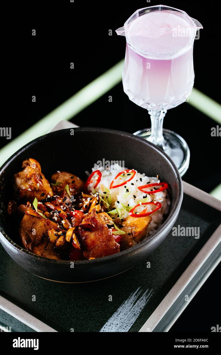 Asian style chicken wings with rice on a black background Stock Photo ...