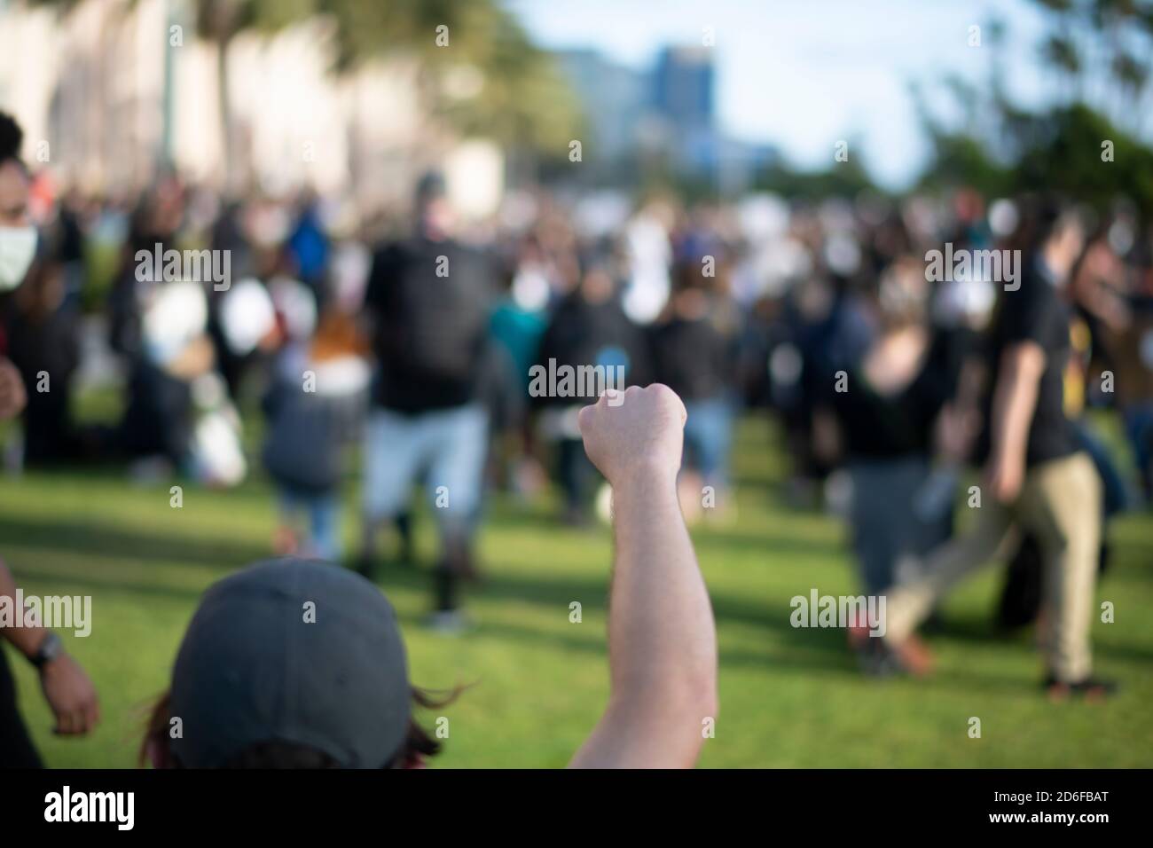 white arm and fist being raised at a peaceful rally Stock Photo - Alamy