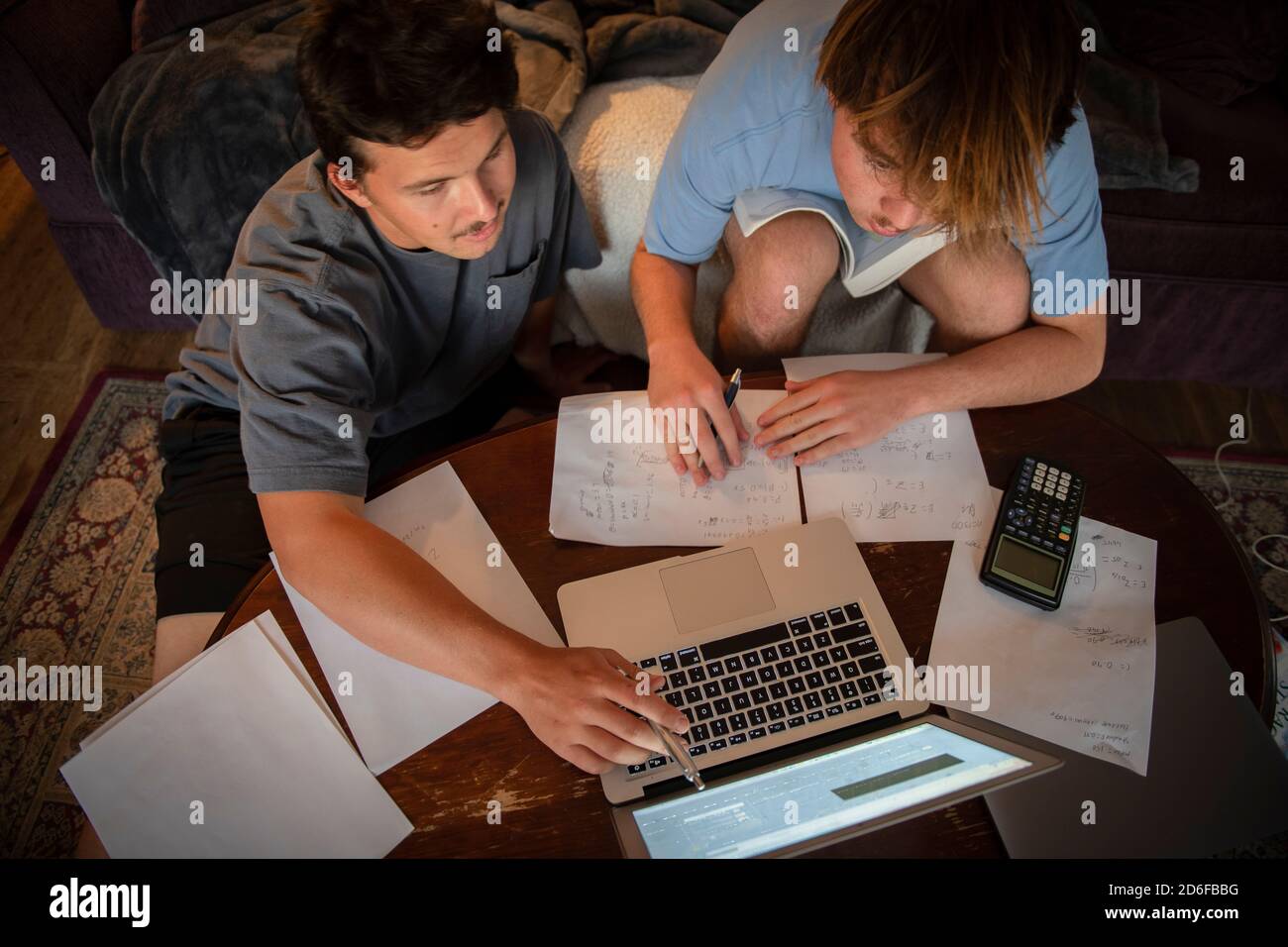 overhead view of 2 college students doing math homework at home Stock ...