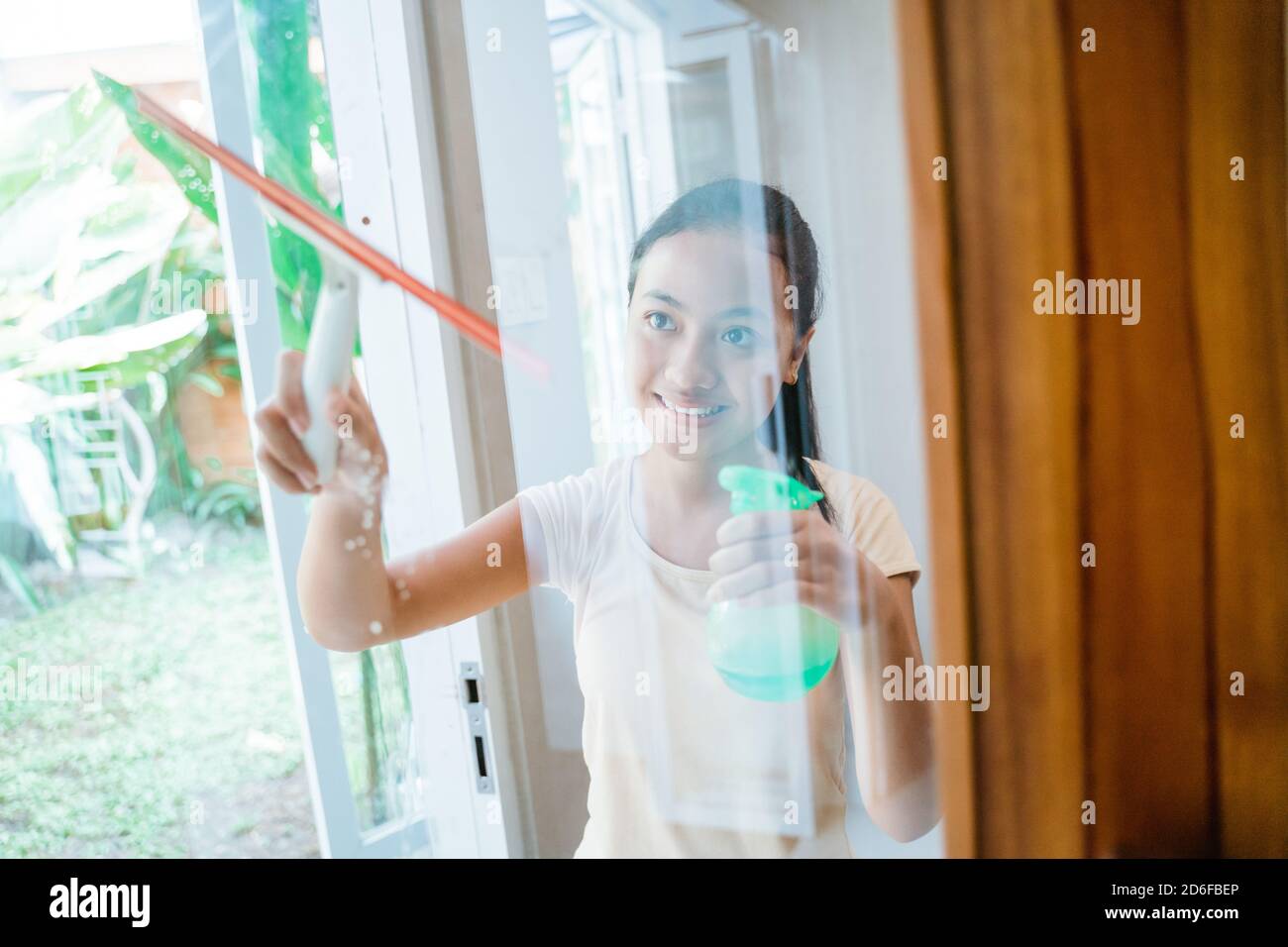 happy young teenage girl washes a window Stock Photo - Alamy
