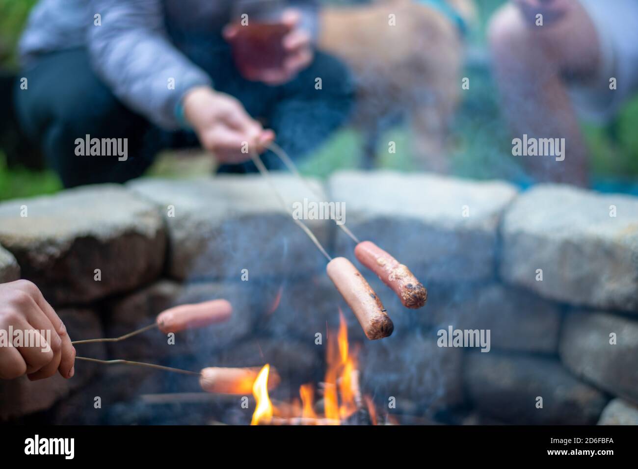 Hot dogs being roasted over a camp fire Stock Photo - Alamy