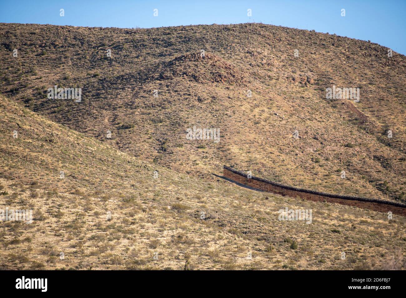 United States Mexico border fence stops mountain desert terrain Stock ...