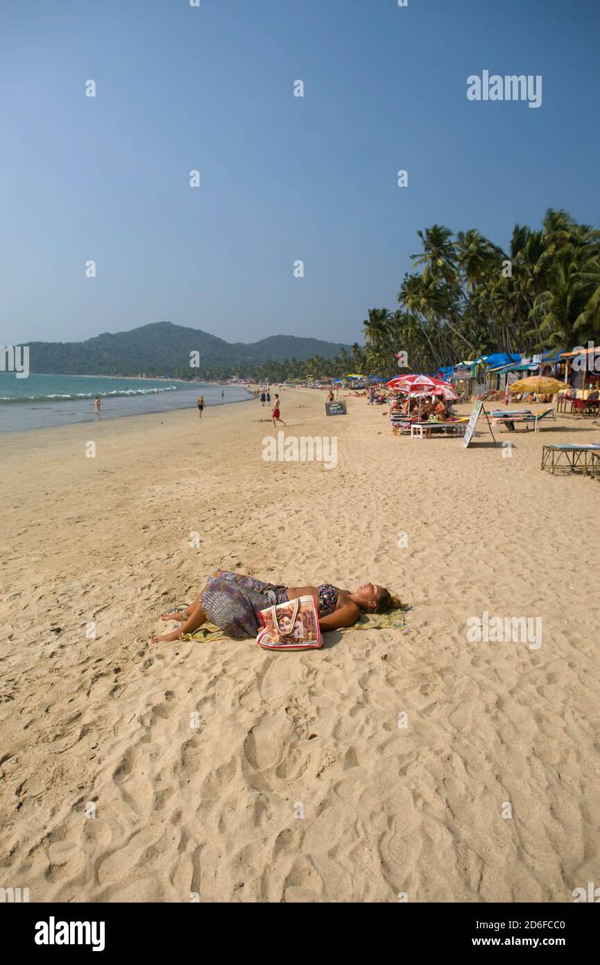 Sunbathing on a beach in Goa Stock Photo - Alamy