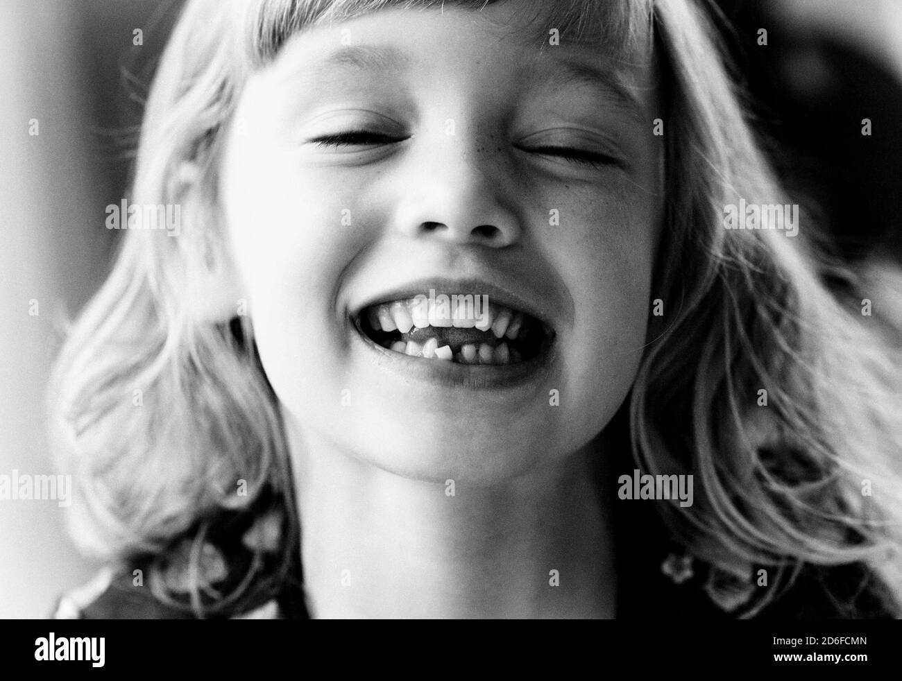 portrait of a young girl showing her wobbly tooth smiling Stock Photo ...