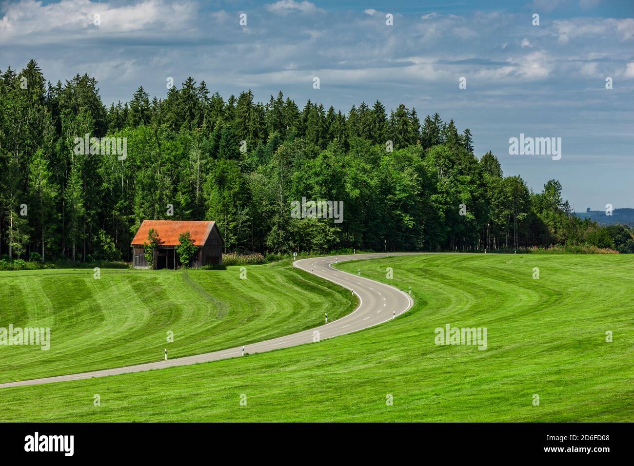 Country road in a green hilly landscape hi-res stock photography and ...