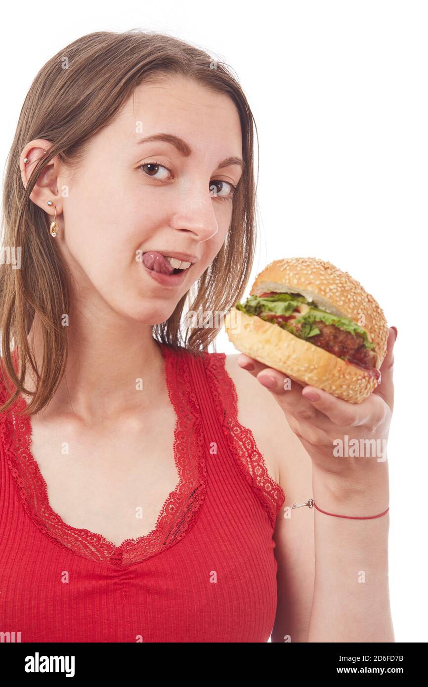 happy young woman show cheeseburger on white background isolated ...