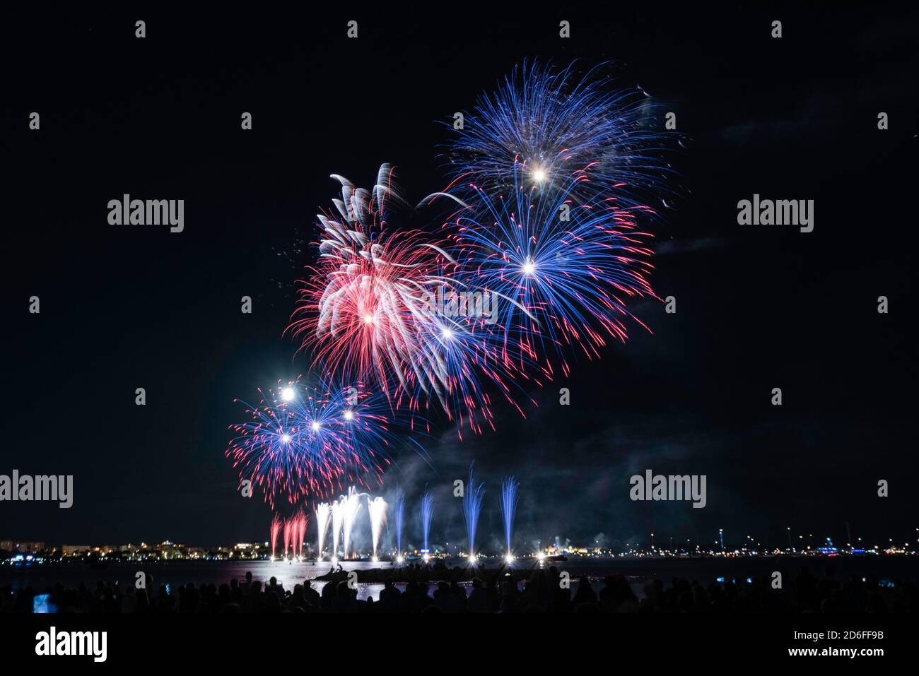 Scenic fireworks glowing in the night for the 14th of July celebrations ...