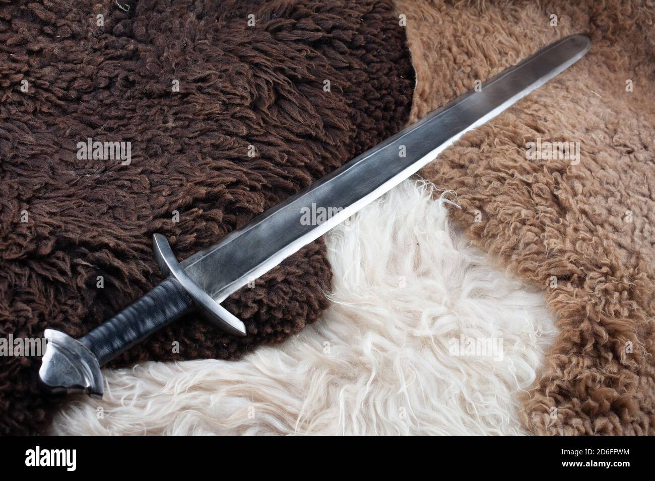Viking Age sword on sheep fur background Stock Photo - Alamy