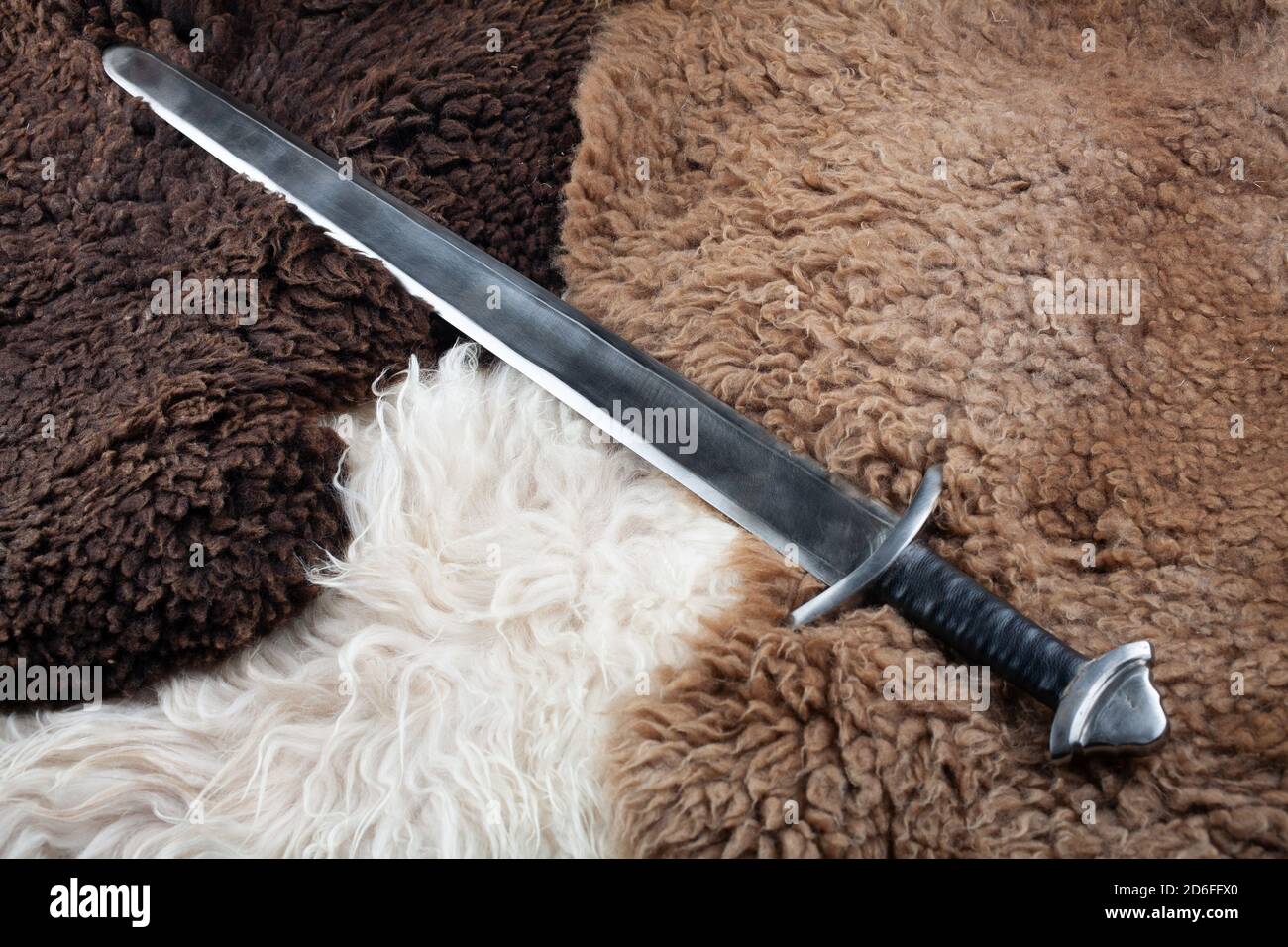Viking Age sword on sheep fur background Stock Photo - Alamy