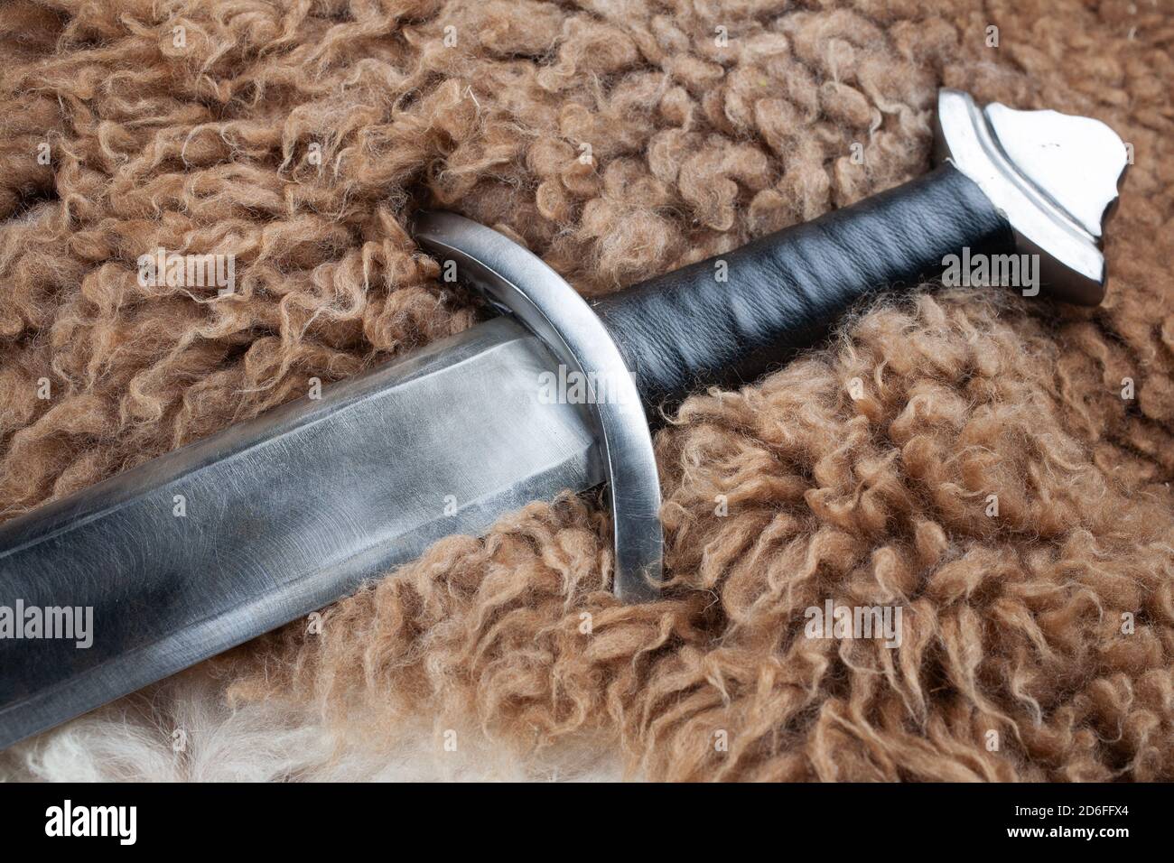 Viking Age sword on sheep fur background Stock Photo - Alamy