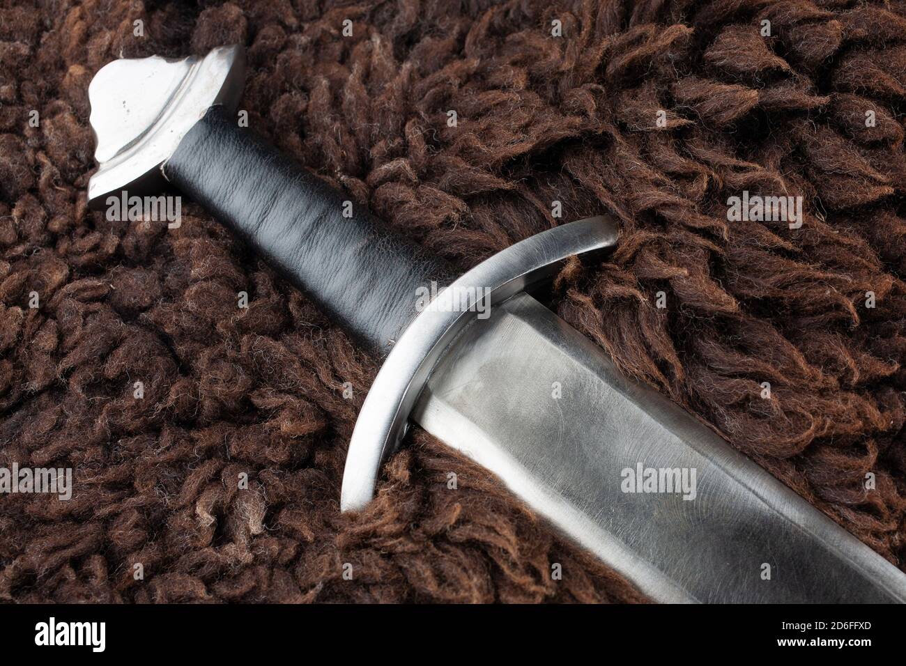 Viking Age sword on sheep fur background Stock Photo - Alamy