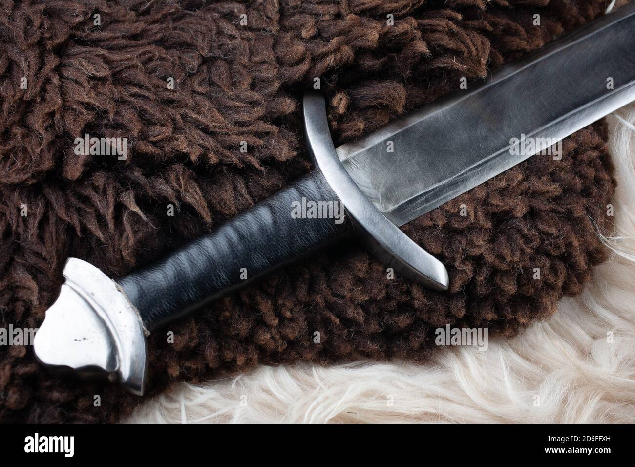 Viking Age sword on sheep fur background Stock Photo - Alamy