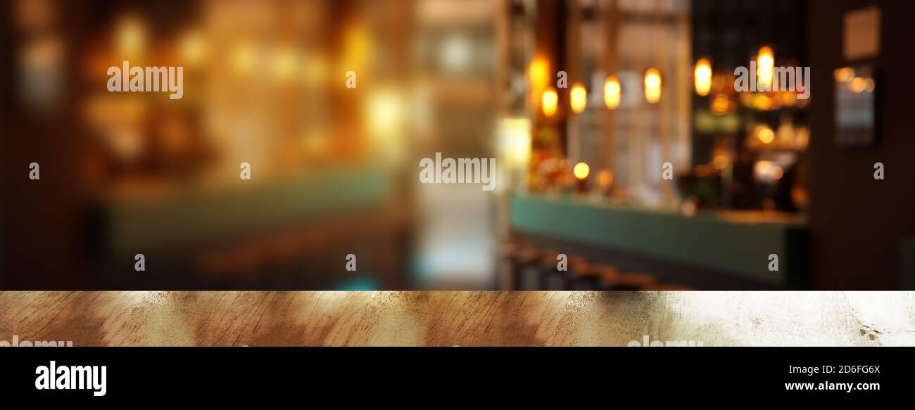 top of wood table or counter with blur light in pub or bar night party ...