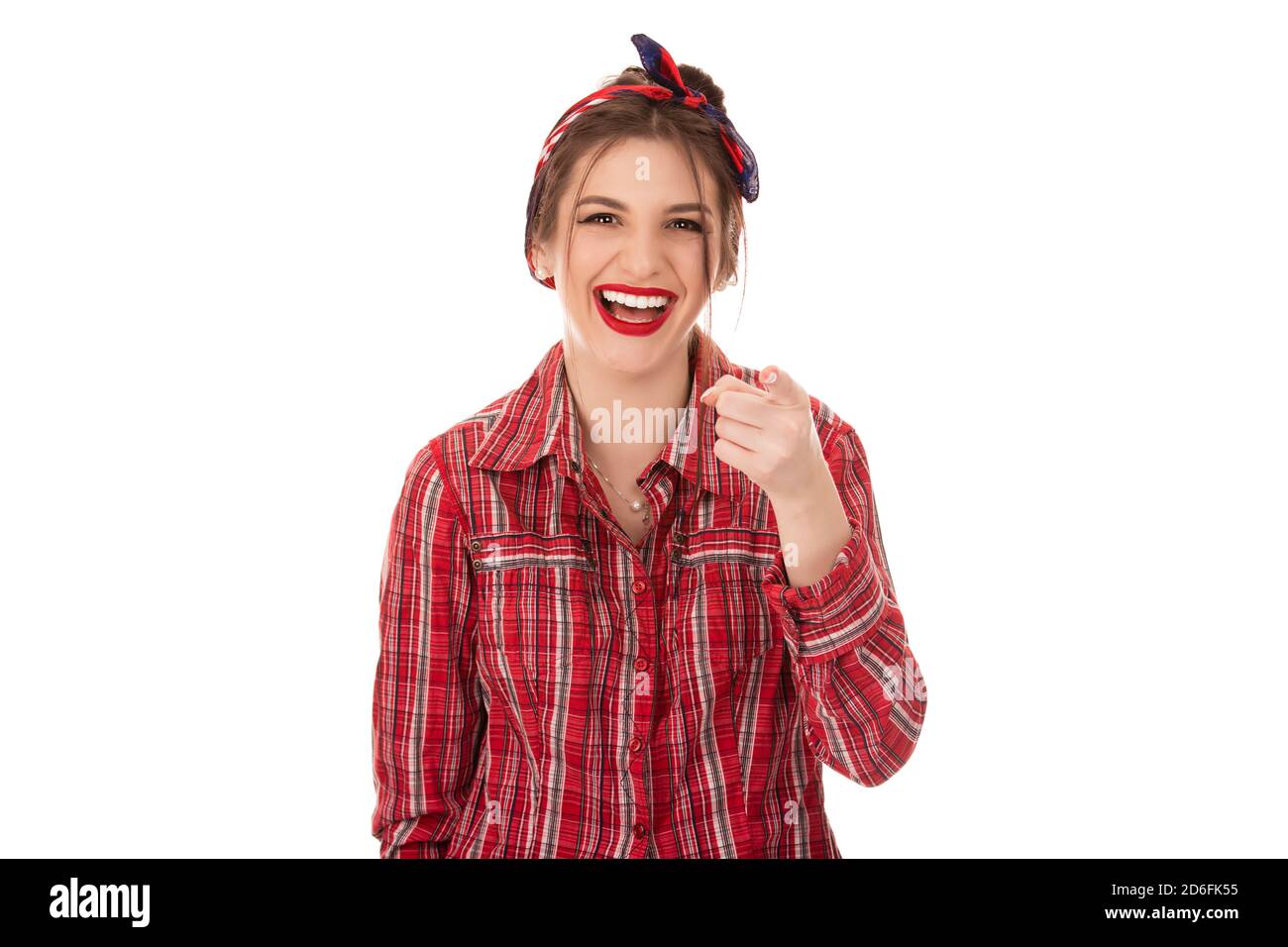 Pointing and laughing. Portrait of young smiling woman pointing finger ...