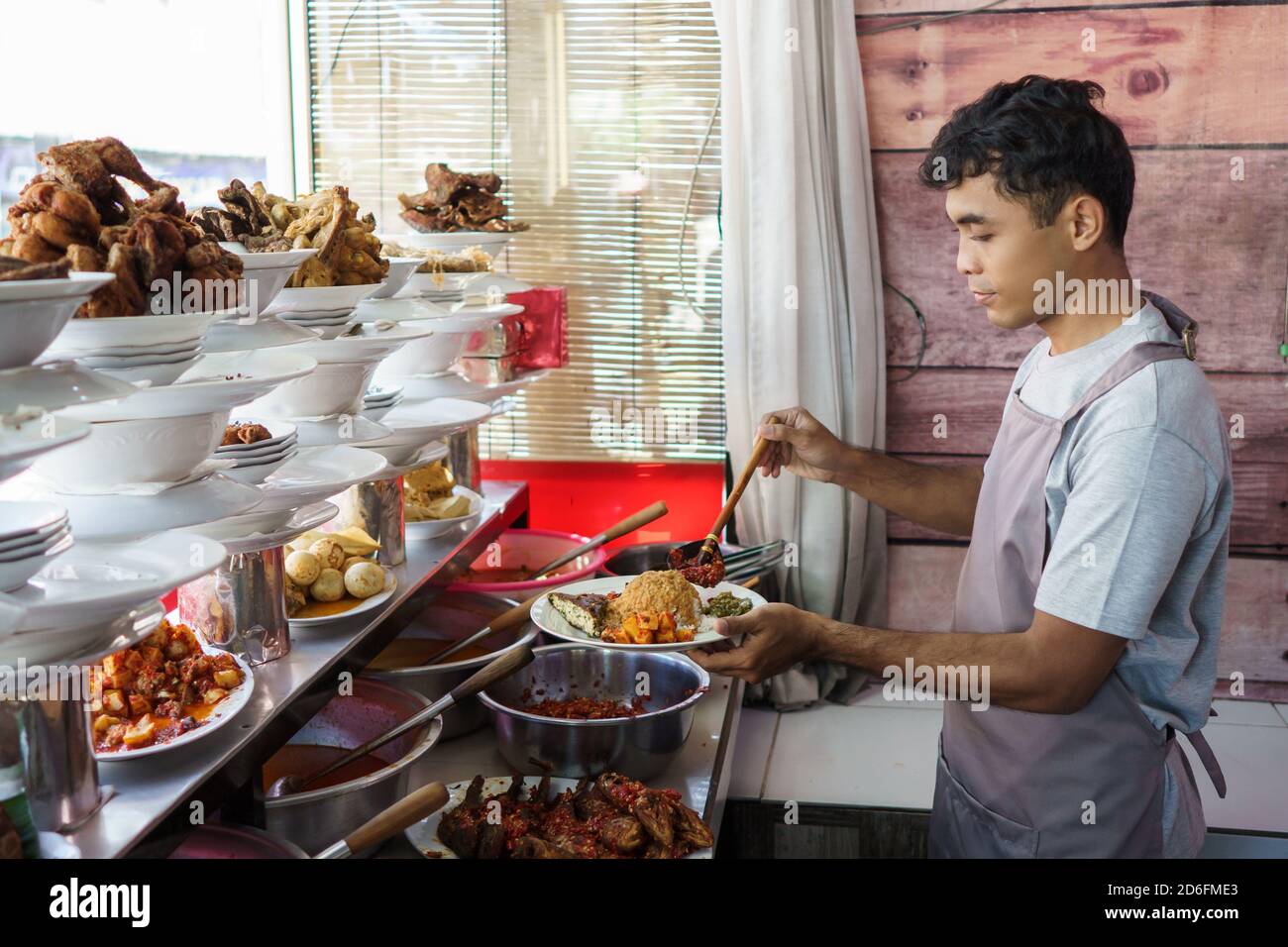 Portrait Young Man Who Prepares The Dish Traditional Food Stock Photo portrait-young-man-who-prepares-the-dish-traditional-food-stock-photo