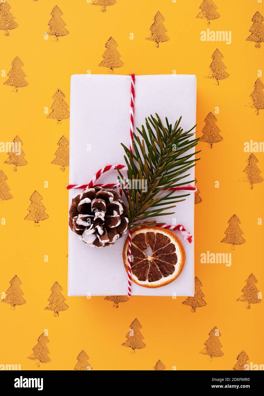 Flat lay of a white decorated gift box, Christmas trees pattern in the ...