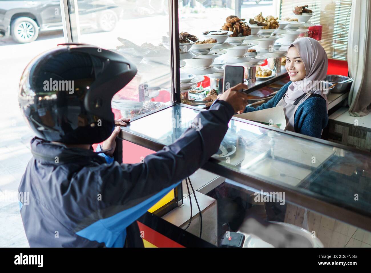a man shows his order from mobile to waiter Stock Photo - Alamy