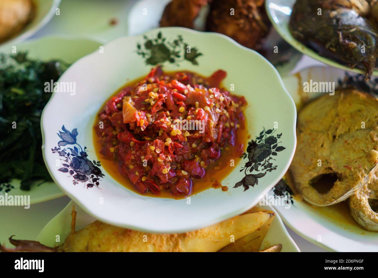 portrait of red chilli sauce on a plate on in a traditional food dish ...