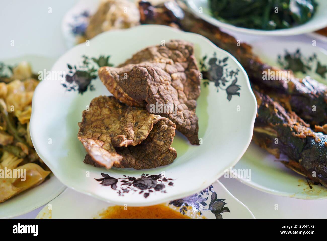 portrait fried beef lung food on a plate on in a traditional food dish ...