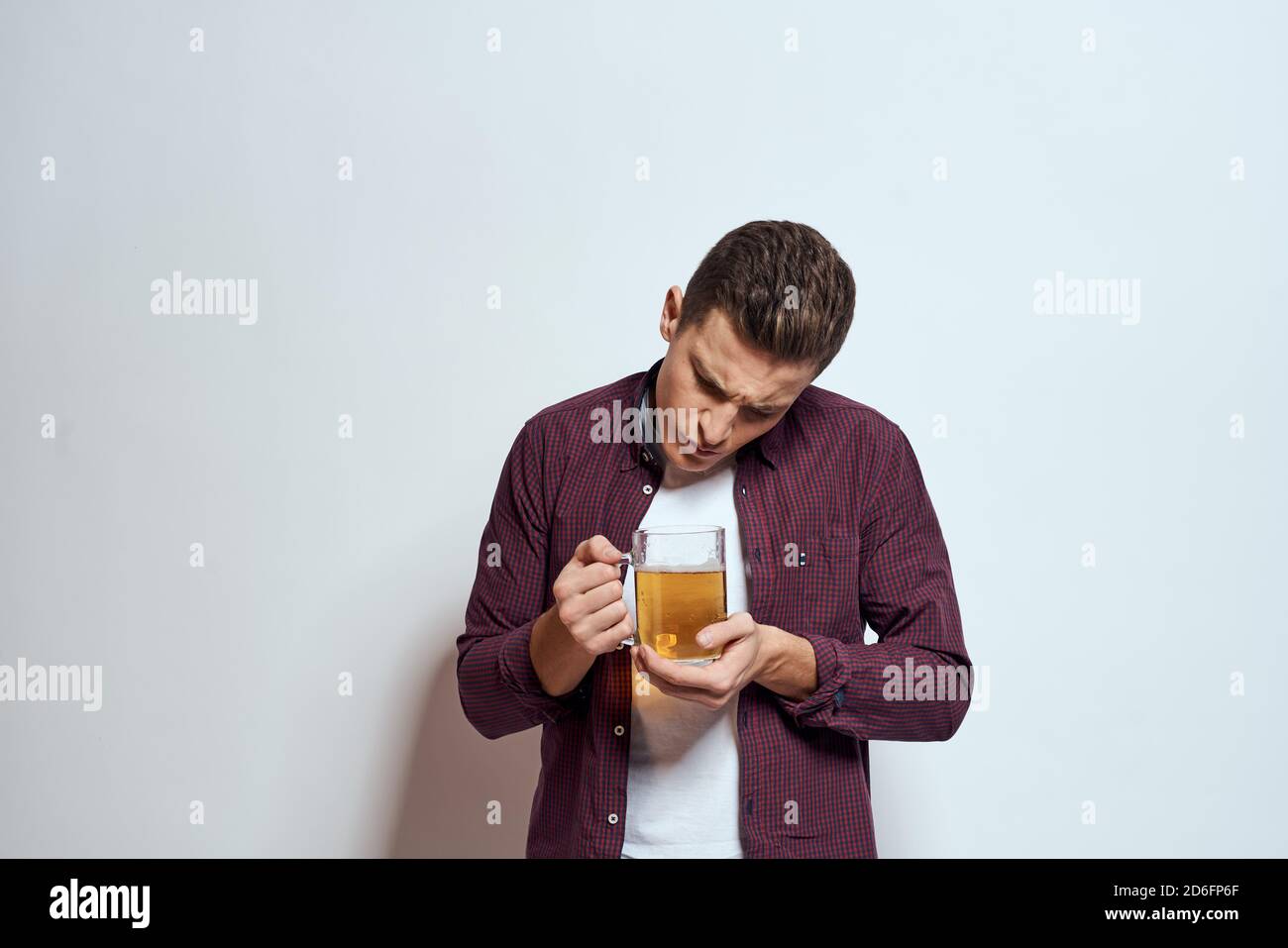 Drunk man with a mug of beer vacation alcohol lifestyle in a red shirt ...