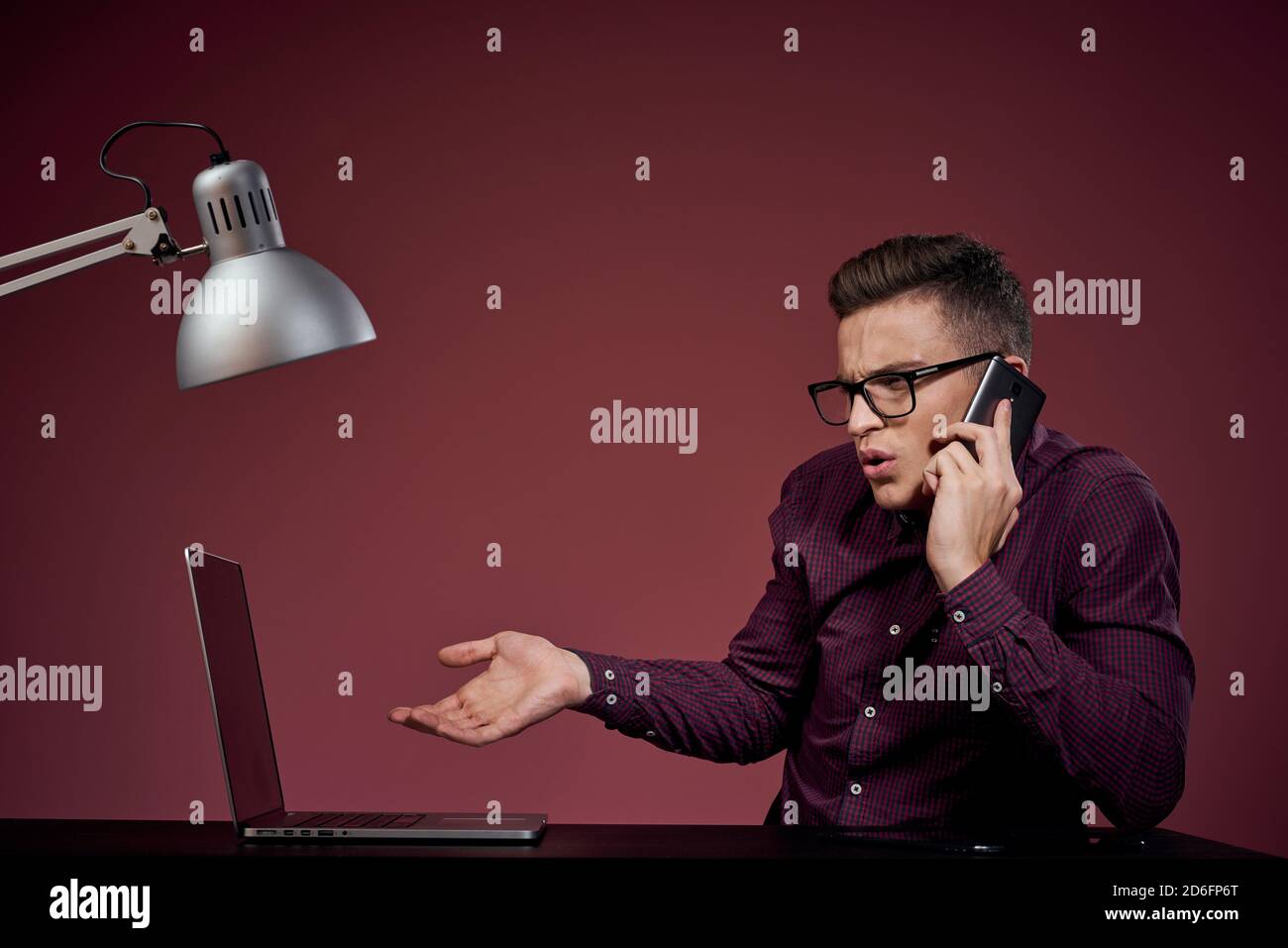 Business man in office and talking on the phone manager red background ...