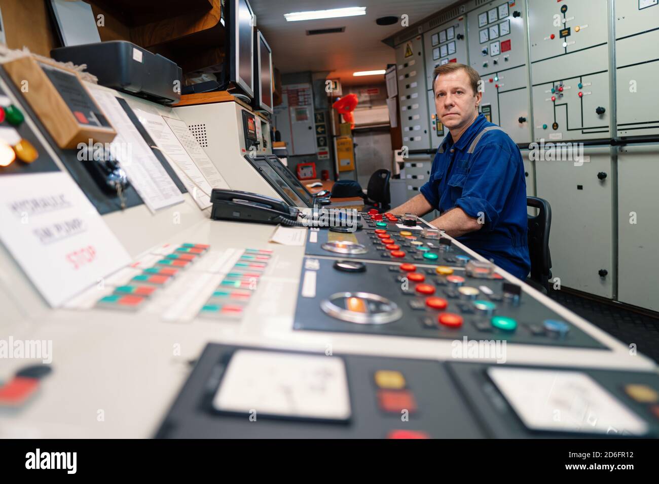 Marine engineer officer controlling vessel engines and propulsion in ...