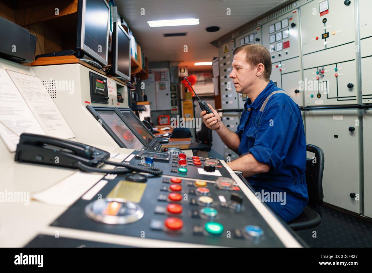 Marine engineer officer controlling vessel engines and propulsion in ...