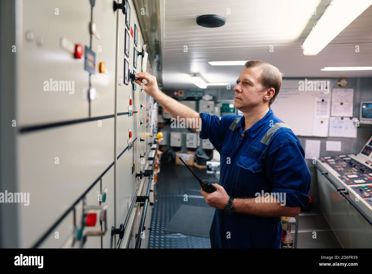 Marine engineer officer controlling vessel engines and propulsion in ...