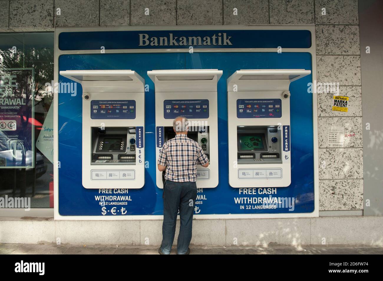 A man using a banking ATM in Istanbul Stock Photo - Alamy