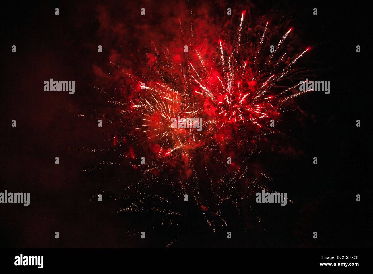 Bright red fireworks in the night sky Stock Photo - Alamy