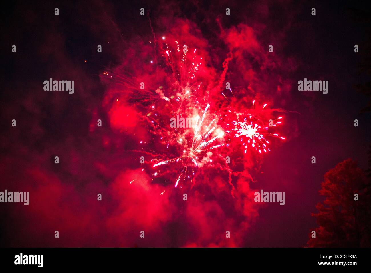 Bright red fireworks in the night sky Stock Photo - Alamy