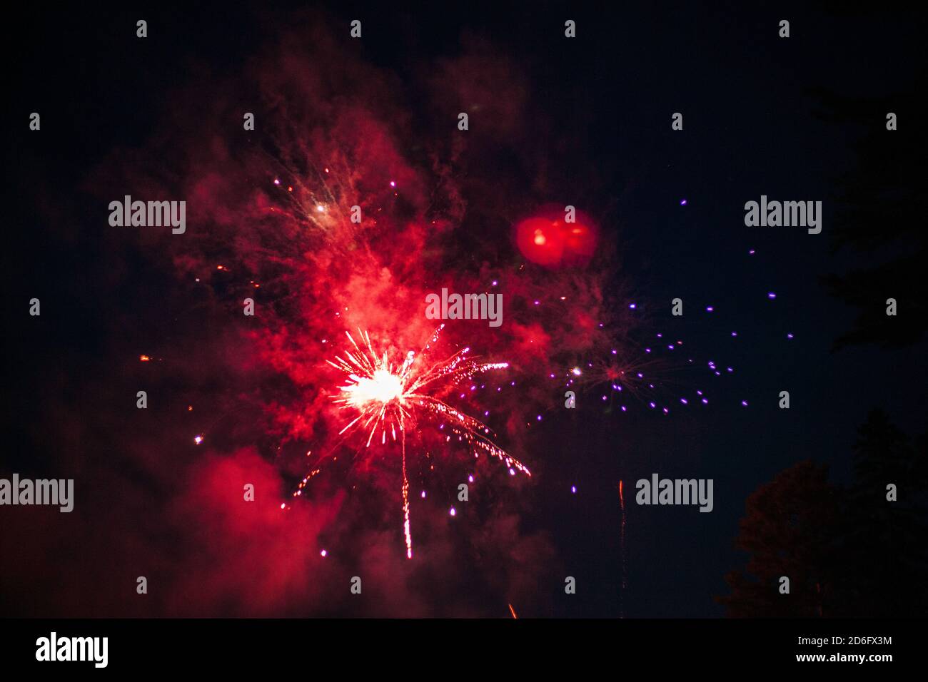 Bright red fireworks in the night sky Stock Photo - Alamy
