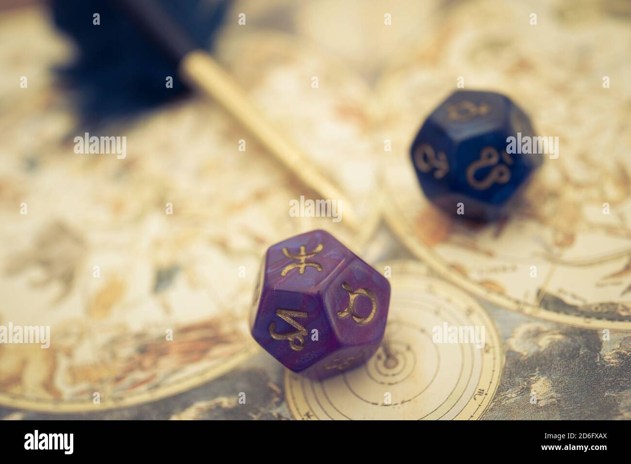antique astrology chart with zodiac signs and dice with a quill pen ...