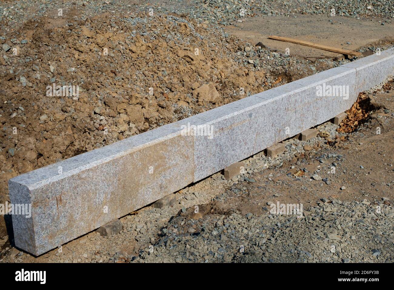Construction work. Road curb made of granite slabs installed on a ...