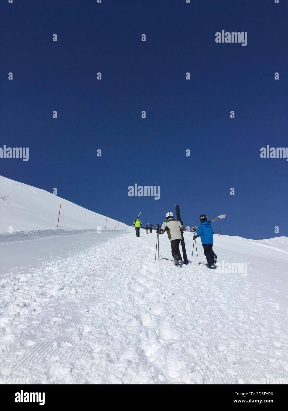 Skiers hike to mountain summit Stock Photo - Alamy