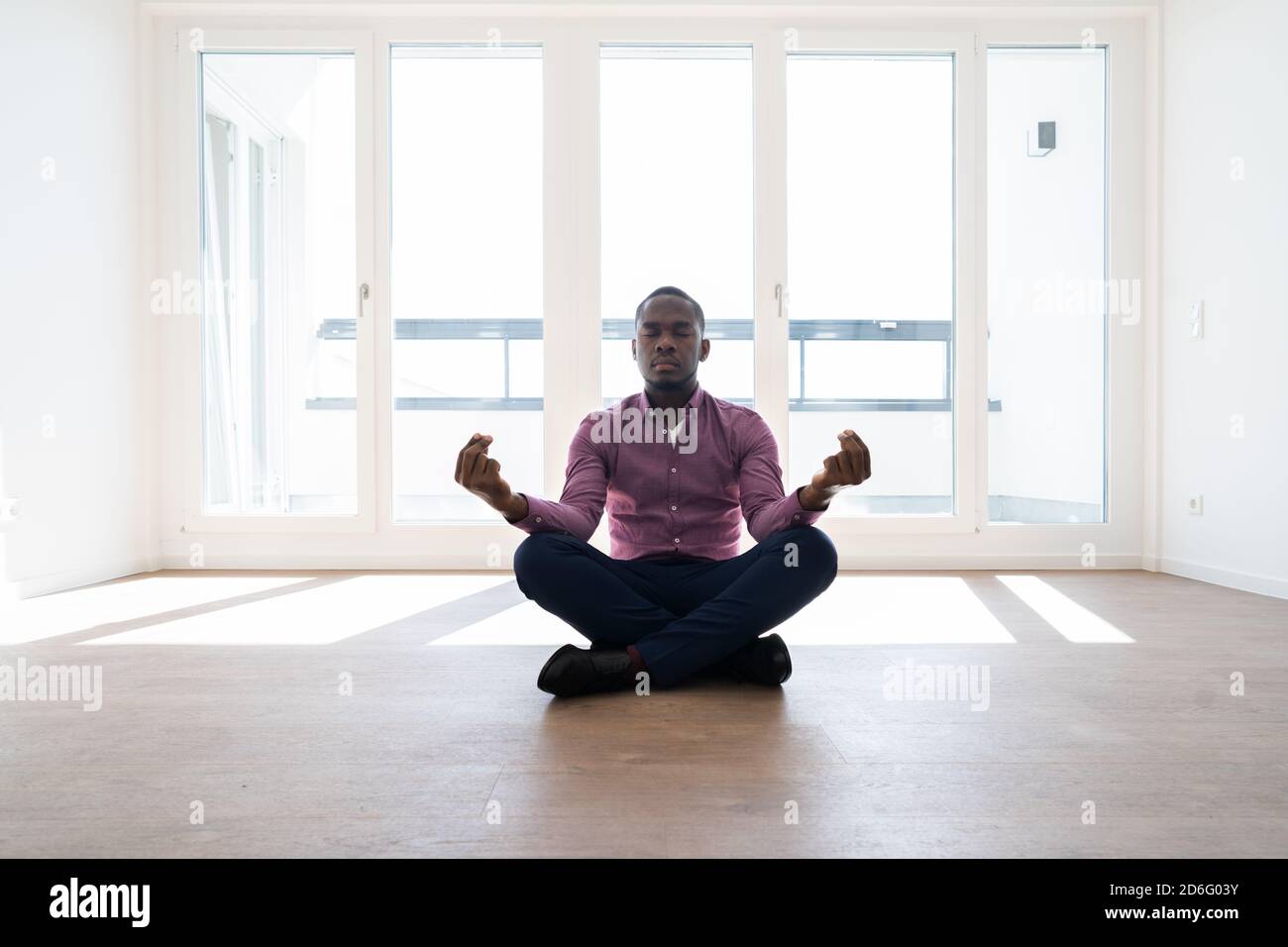 African American Man Meditating And Relaxing In Empty Room Stock Photo ...