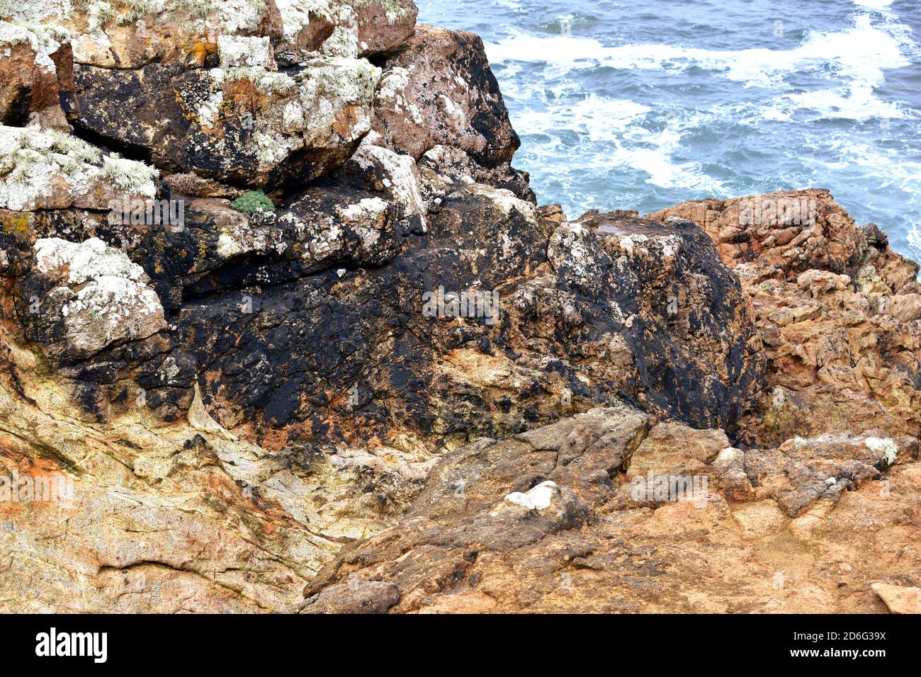 Rocks with oil spill from the sinking of oil tanker MV Prestige in 2002 ...