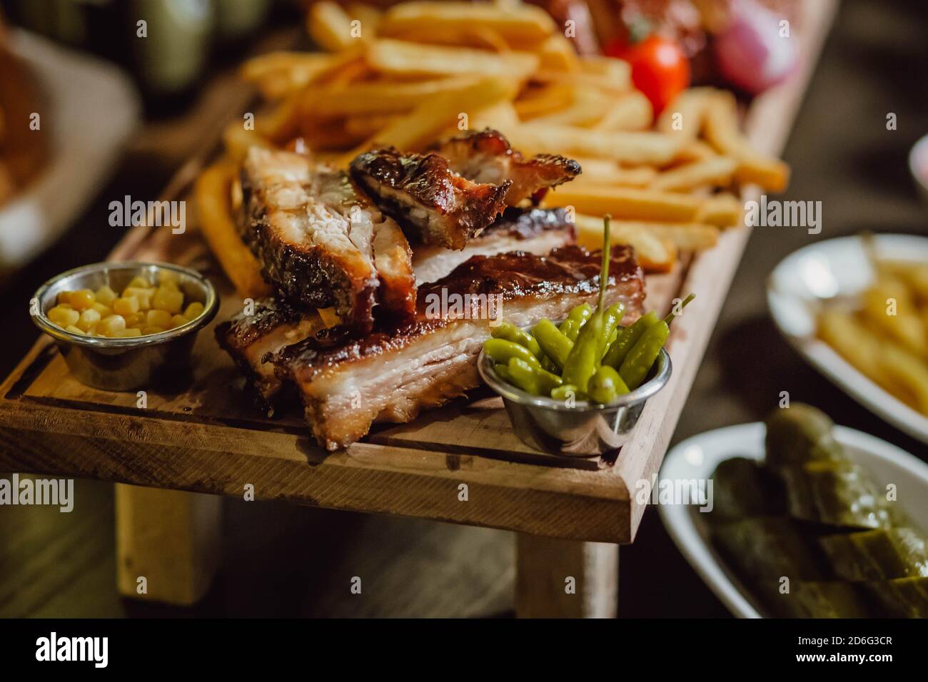 Delicious ribs with potatoes. BBQ ribs menu in a restaurant Stock Photo ...