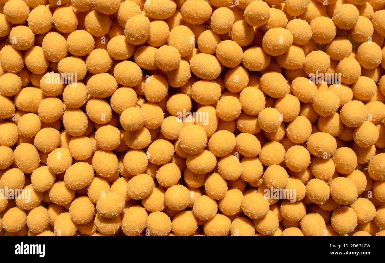 Cheese coated salted peanuts background. Fried peanut grains with a ...