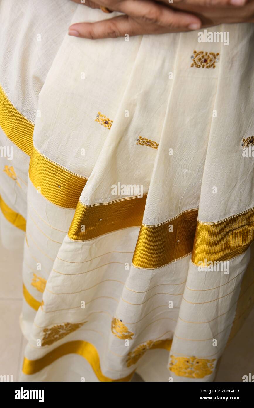 Indian silk sari, handmade white Kerala Sari, woman wearing holding ...